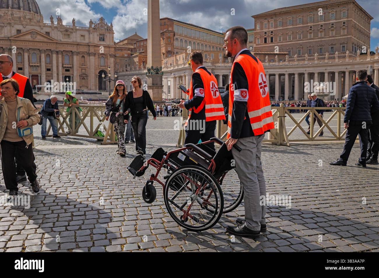 Vatican staff members assisting the disabled in St. Peter s Square ...