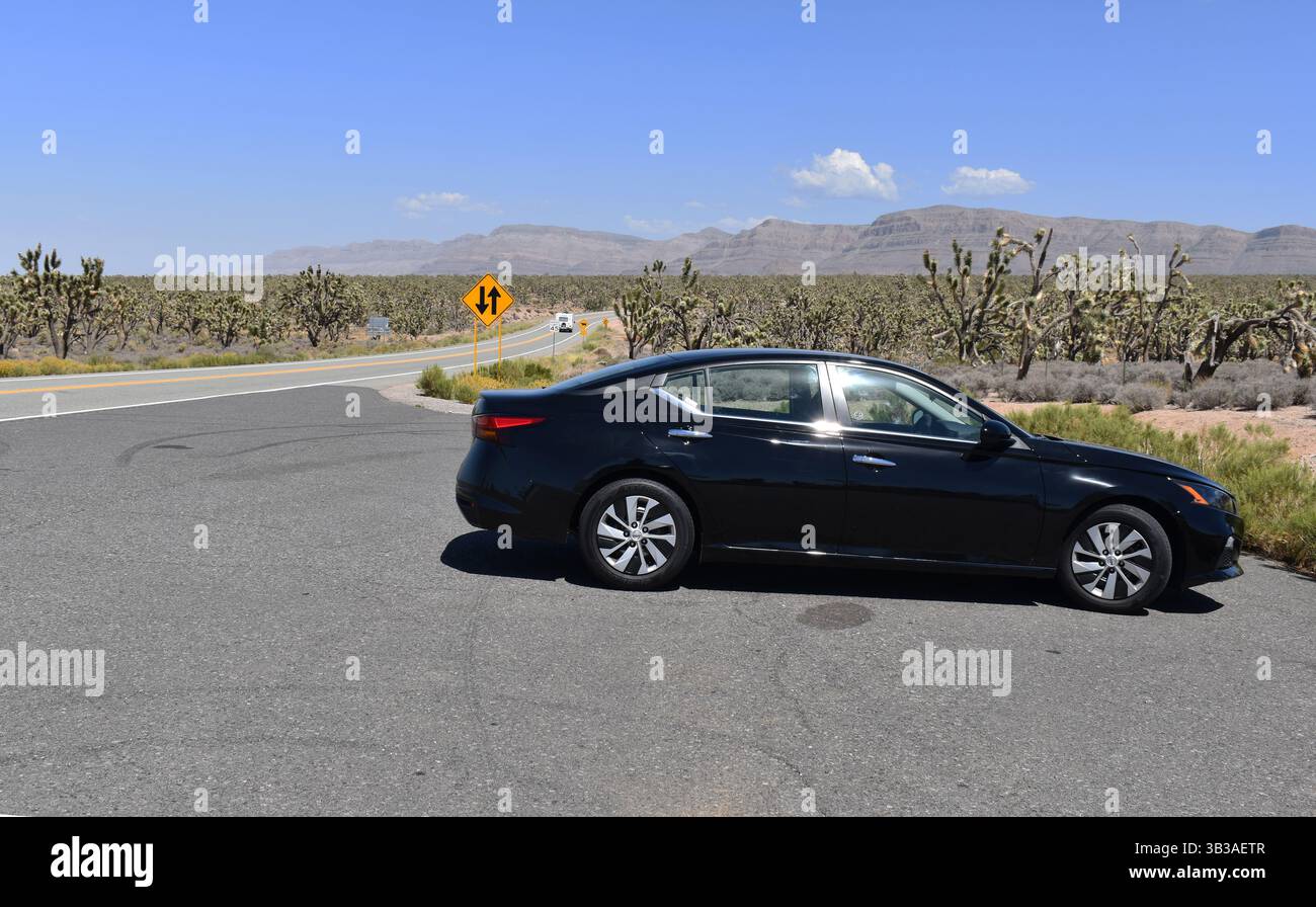 Passenger car on a scenic road surrounded by stunning natural landscape ...