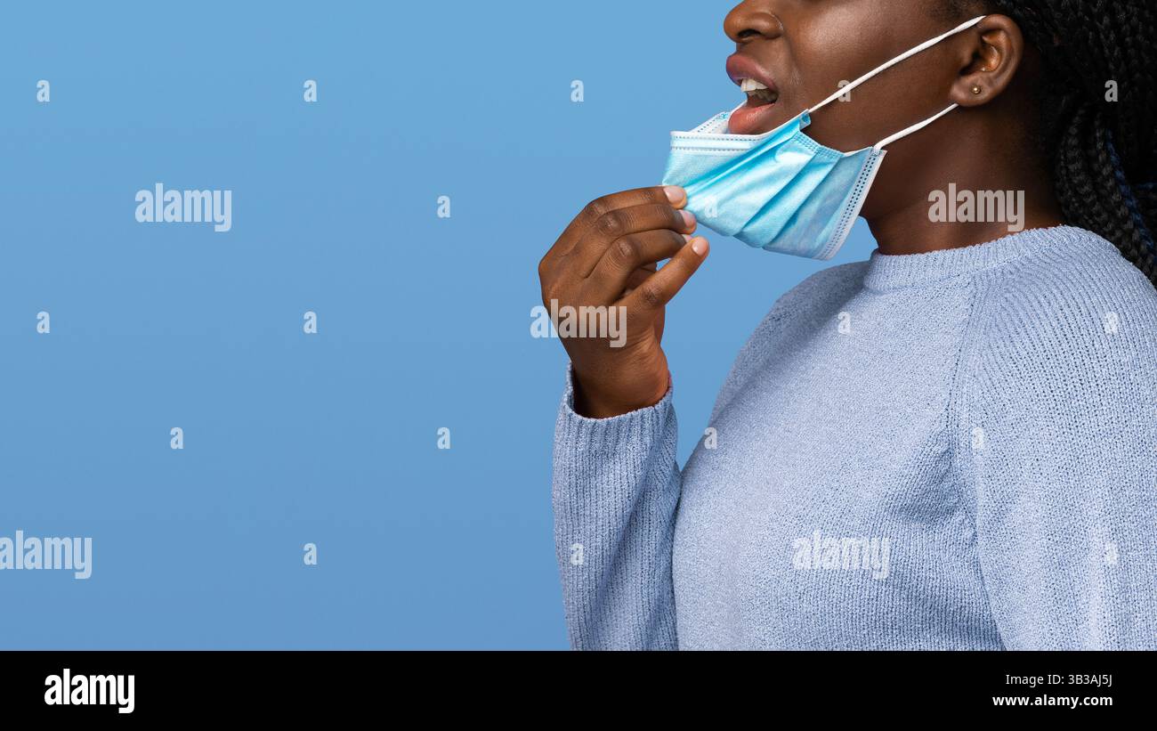 Young Black Woman Taking Off Protective Medical Mask, Can Not Breathe ...