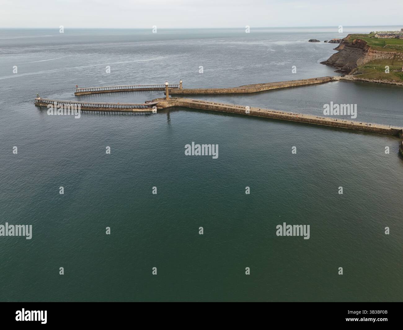 Aerial view of Whitby, seaside resort and fishing port sea wall on the ...