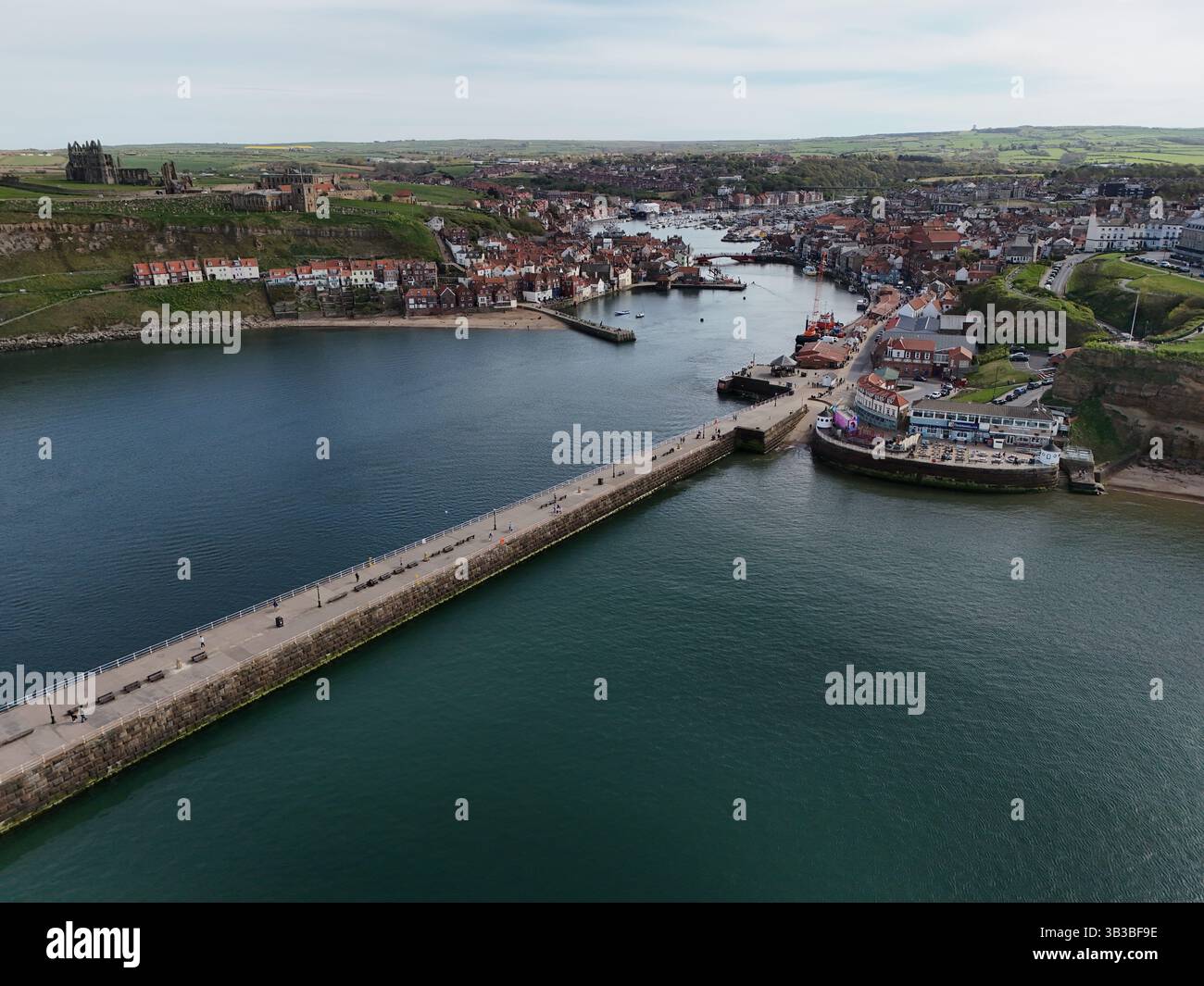 Aerial view of Whitby, seaside resort and fishing port sea wall on the ...