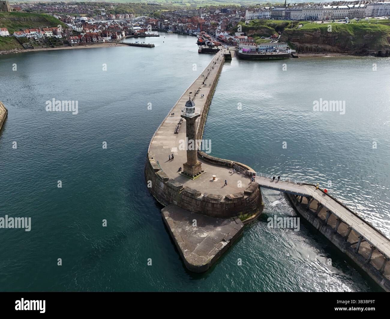 Aerial view of Whitby, seaside resort and fishing port sea wall on the ...