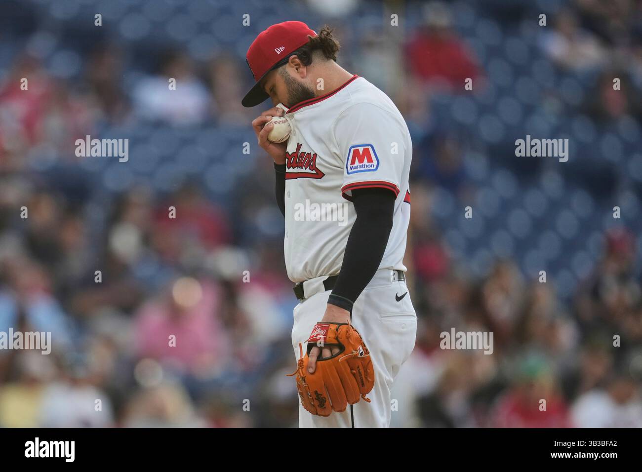 Cleveland Guardians relief pitcher Jakob Junis wipes his face in the ...