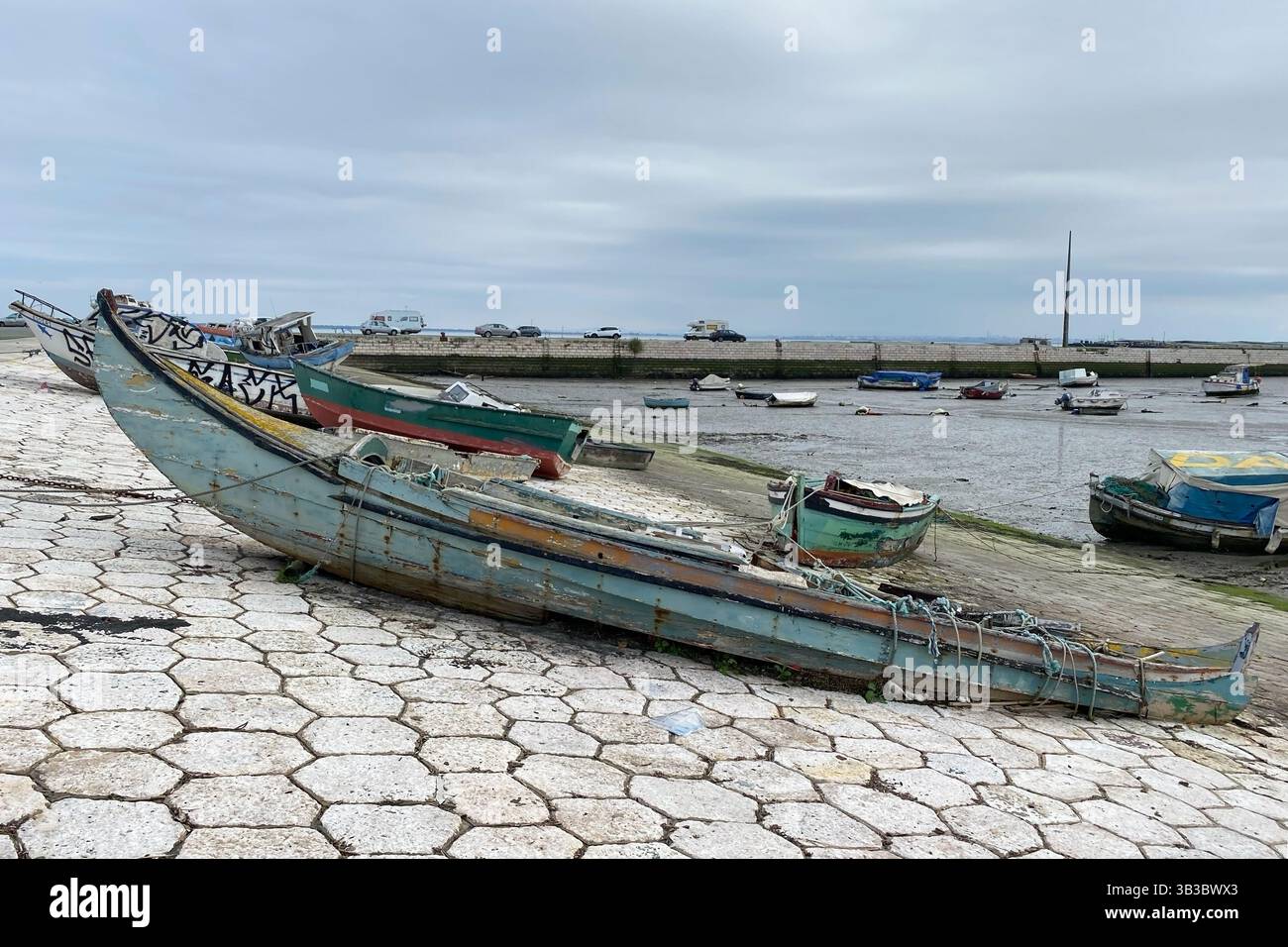 Vintage fishing boat in disrepair moored near old sea port Stock Photo ...