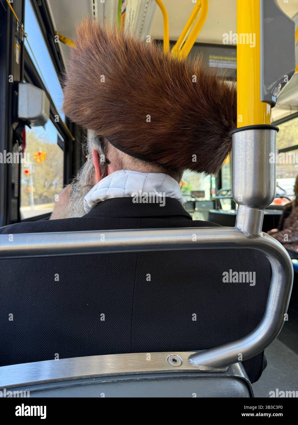 Jewish man riding a bus in Brooklyn, NY during Passover week. The main ...