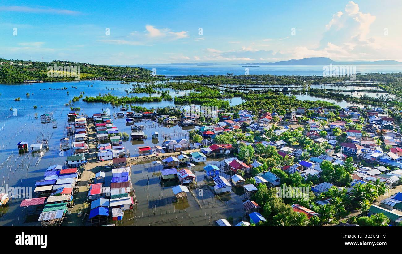 Aerial view over Surigao City looking towards Nonoc and Dinagat Islands across the Surigao ...
