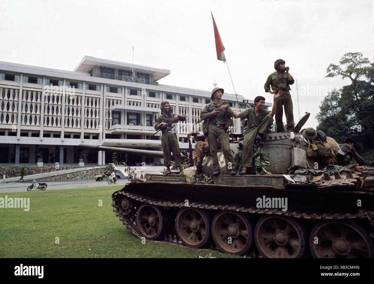FILE- Victorious North Vietnamese troops aboard a tank take a position ...