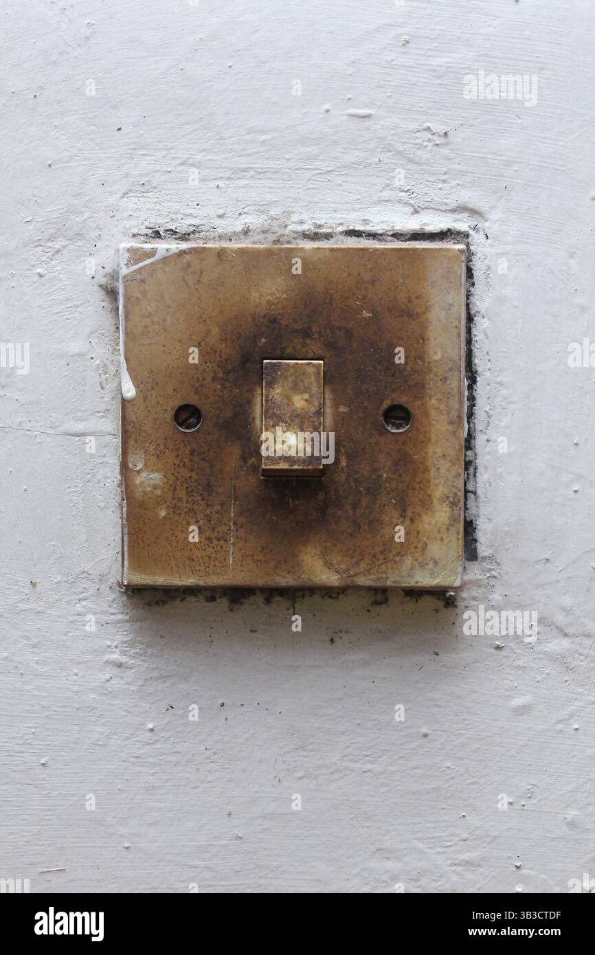 old light switch mounted on white wall Stock Photo - Alamy