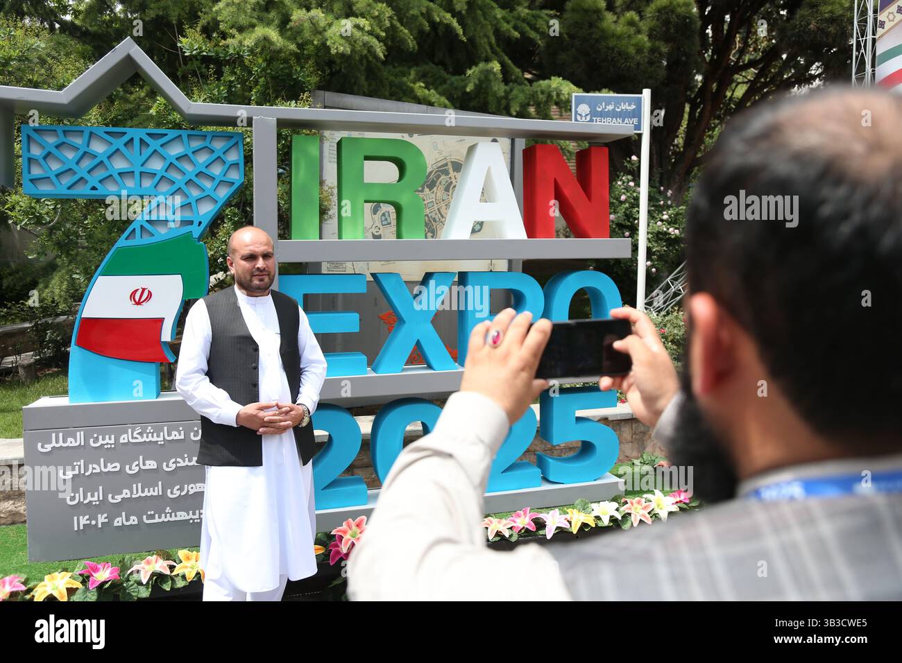 Tehran, Iran. 28th Apr, 2025. A visitor poses for photos at the 7th ...