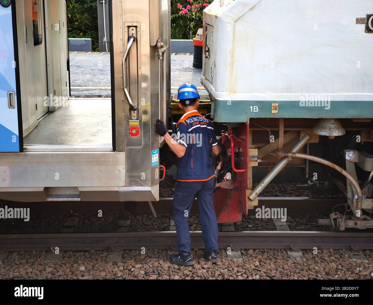 An authorized officer is checking the connection of the locomotive with ...