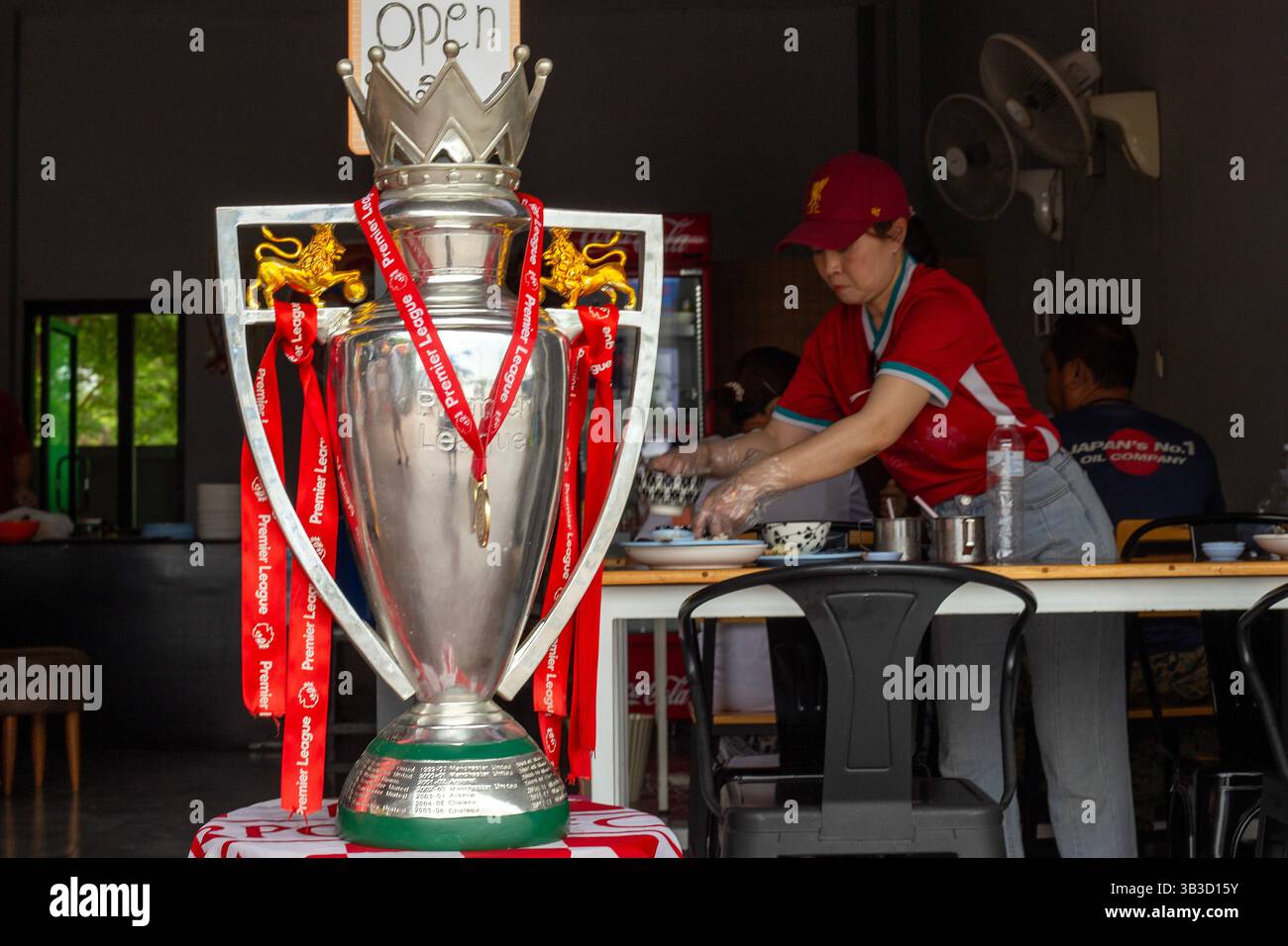 A replica trophy is seen displayed outside a chicken rice restaurant. A ...