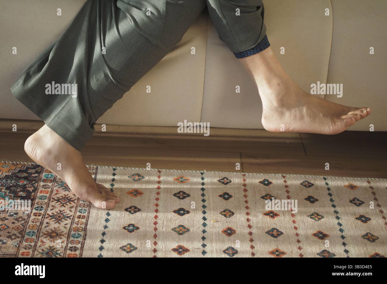 Barefoot relaxation on a cozy rug in a living room setting Stock Photo ...