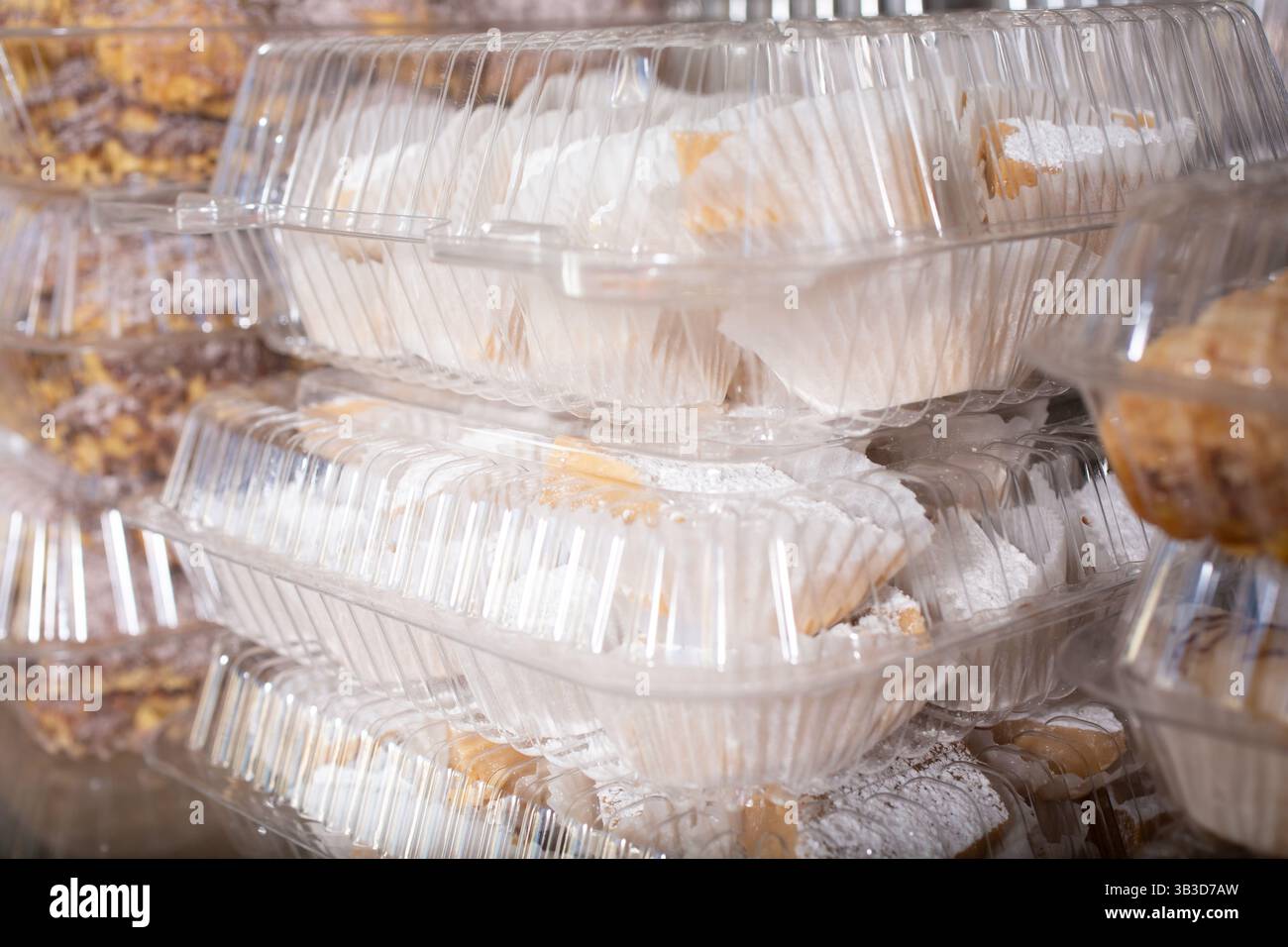 A view of several plastic cookie containers, seen inside a bakery shop ...