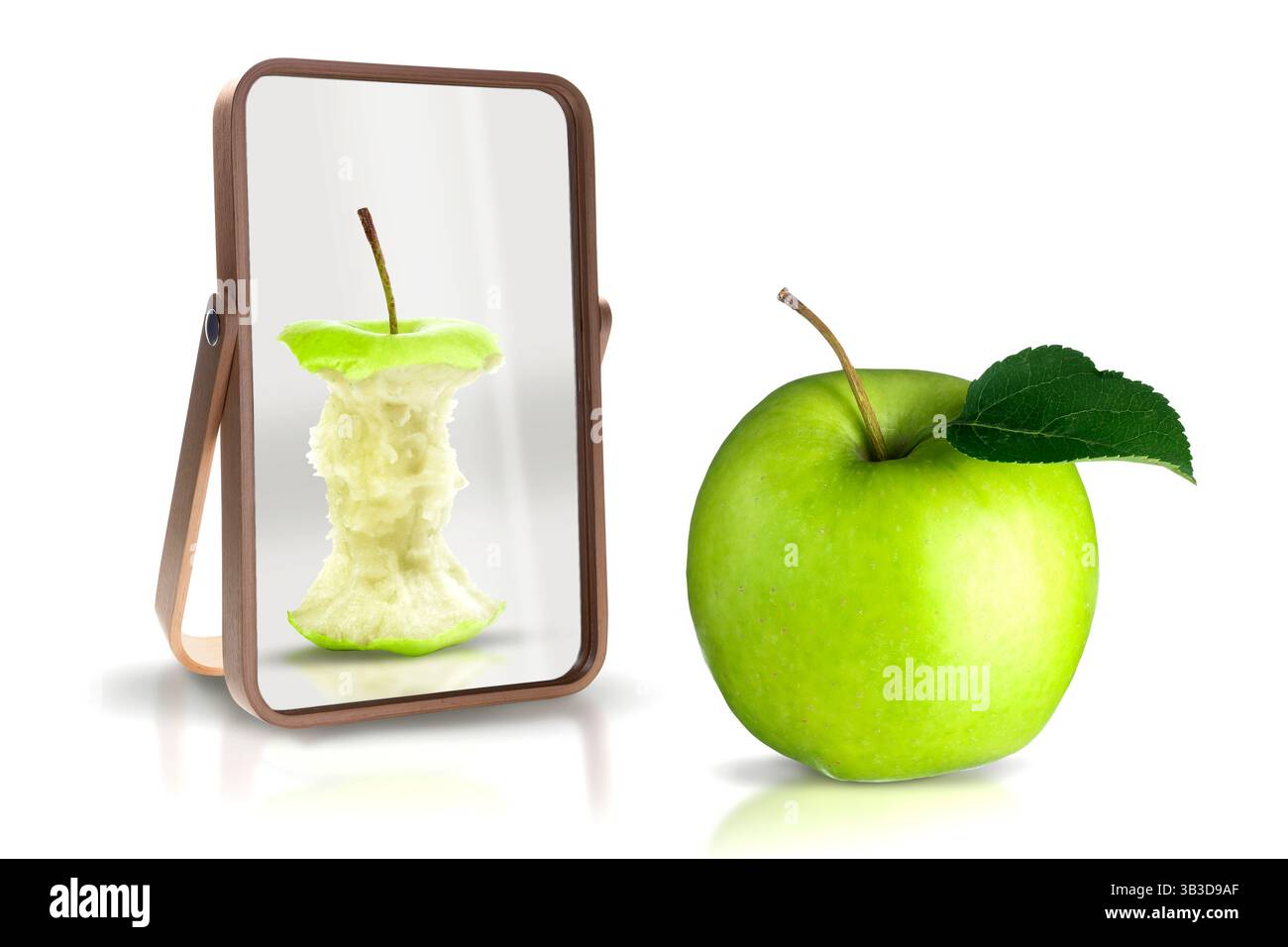Whole apple reflecting in mirror as almost eaten, white background ...