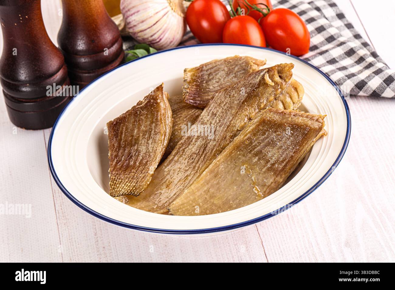 Baked stingray witngs with oil and spices Stock Photo - Alamy