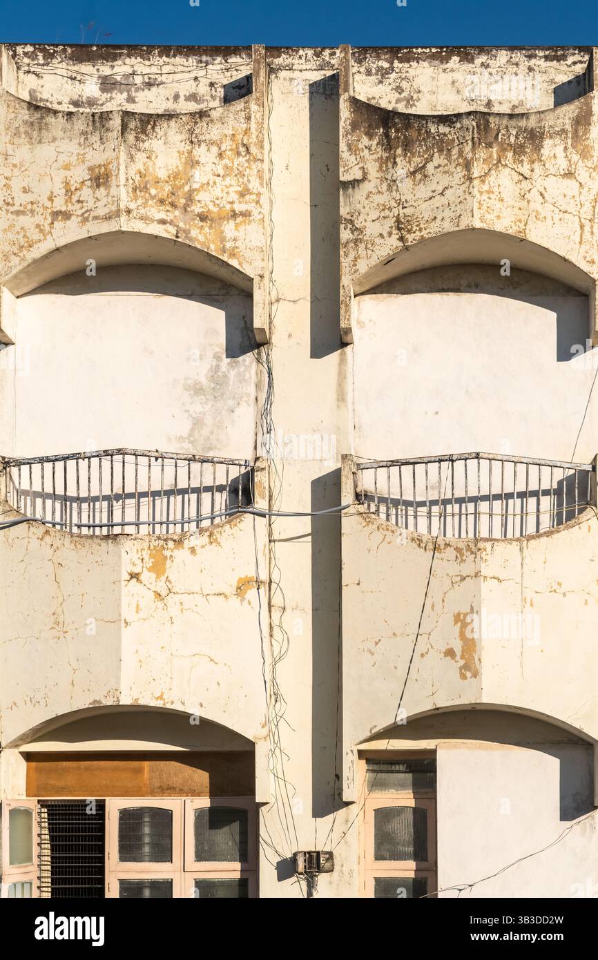 Two small balconies above two windows of houses in an old building ...