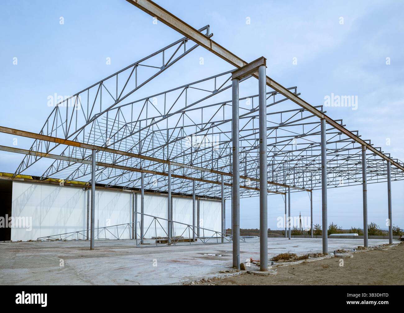Installation of a steel frame under the sip panels of a warehouse with ...