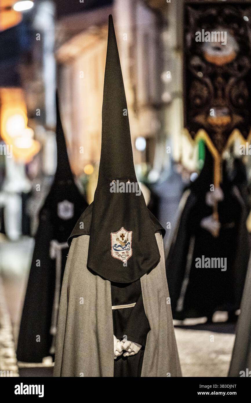 Hooded brothers with conical hats that serve as masks, Holy Week ...