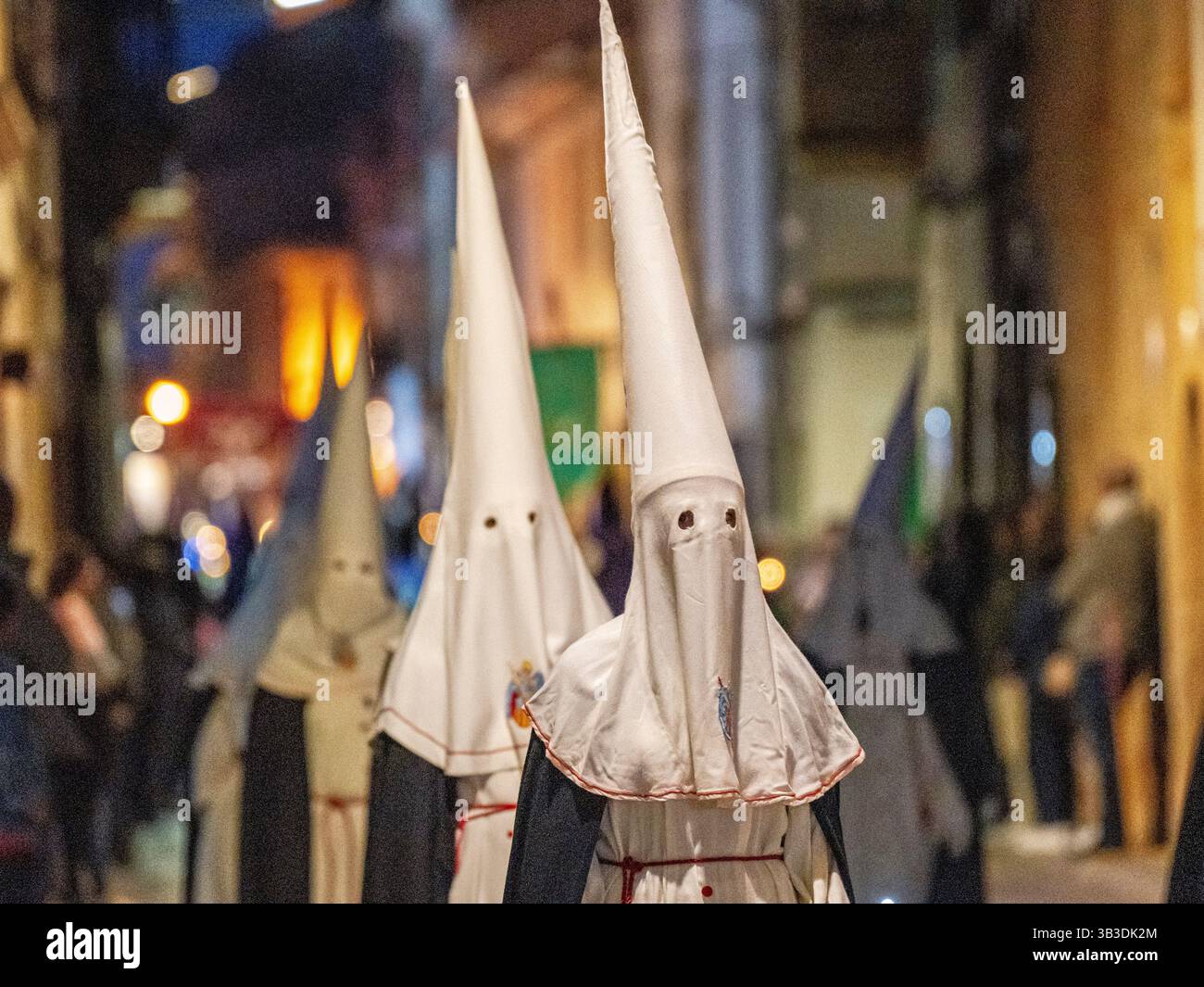 Hooded brothers with conical hats that serve as masks, Holy Week ...