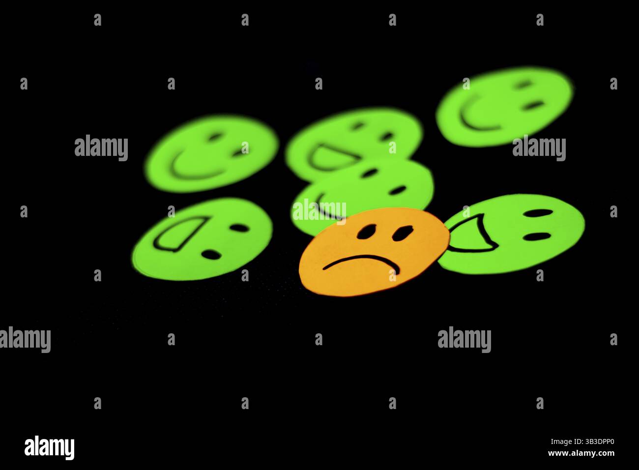 Representation of a sad person in a group of happy people. concept of ...
