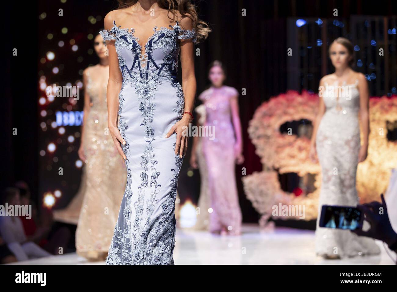 Female models walk the runway in different dresses during a Fashion ...