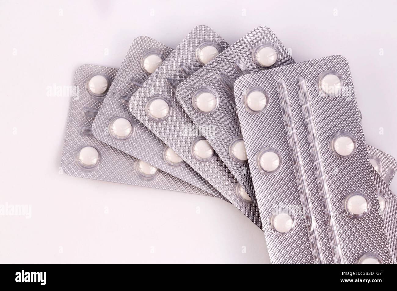 White pills in silver plastic packs - blisters. Global pharmaceutical ...