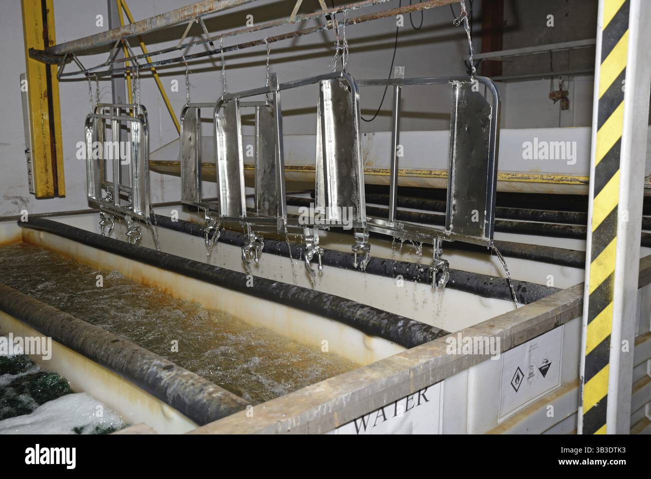 A set of zinc-plated steel gates for an abattoir receive their final ...