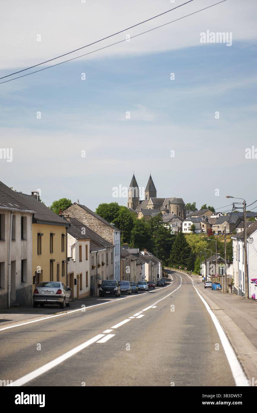 Main street in village Habay with cars and church Stock Photo - Alamy