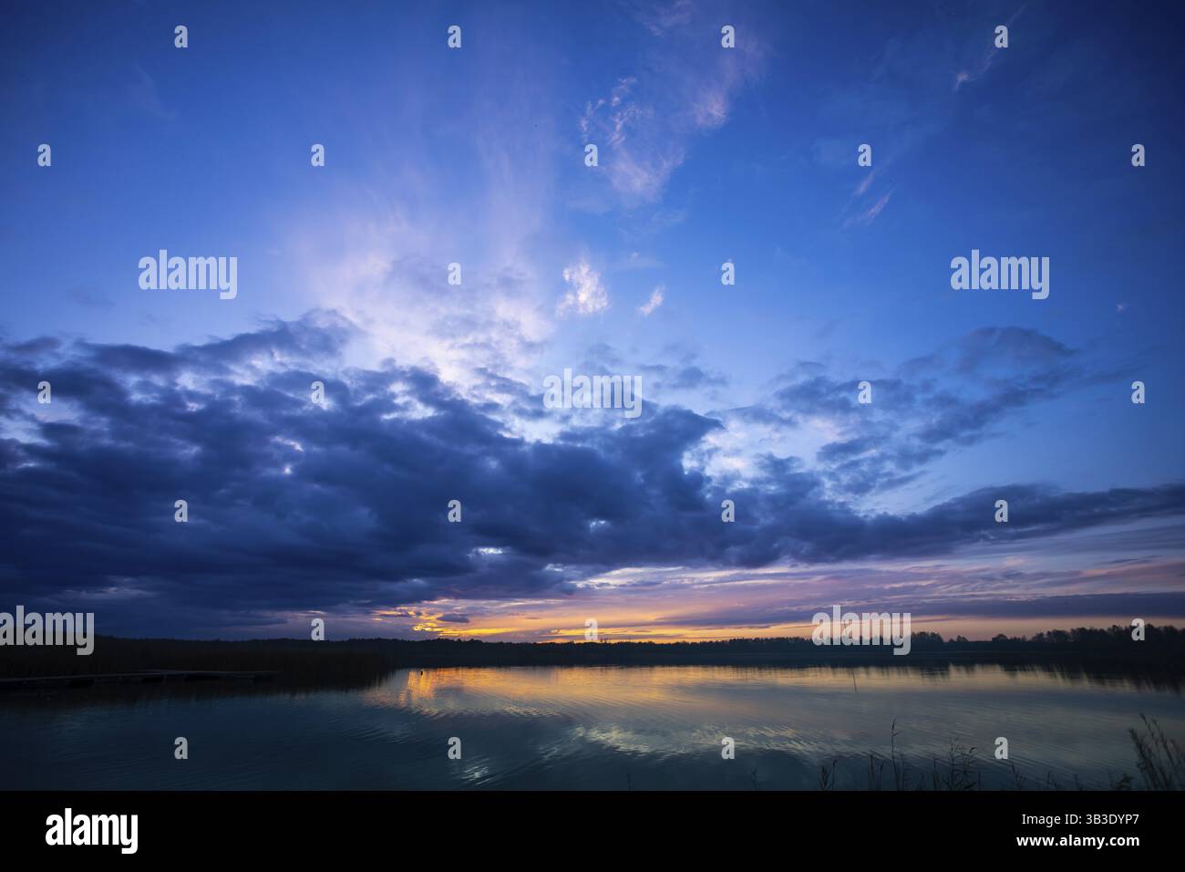 A breathtaking sunset shimmering across a peaceful lake, beautifully ...