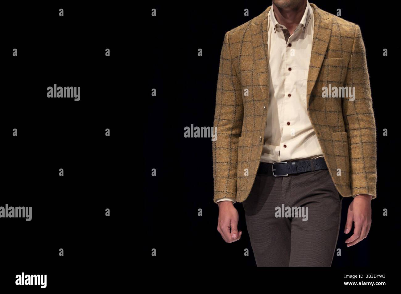 Male model walks the runway in brown suit during a Fashion Show ...