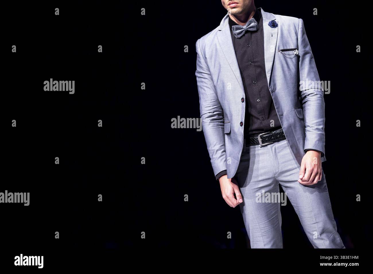 Male model walks the runway in silver suit during a Fashion Show ...