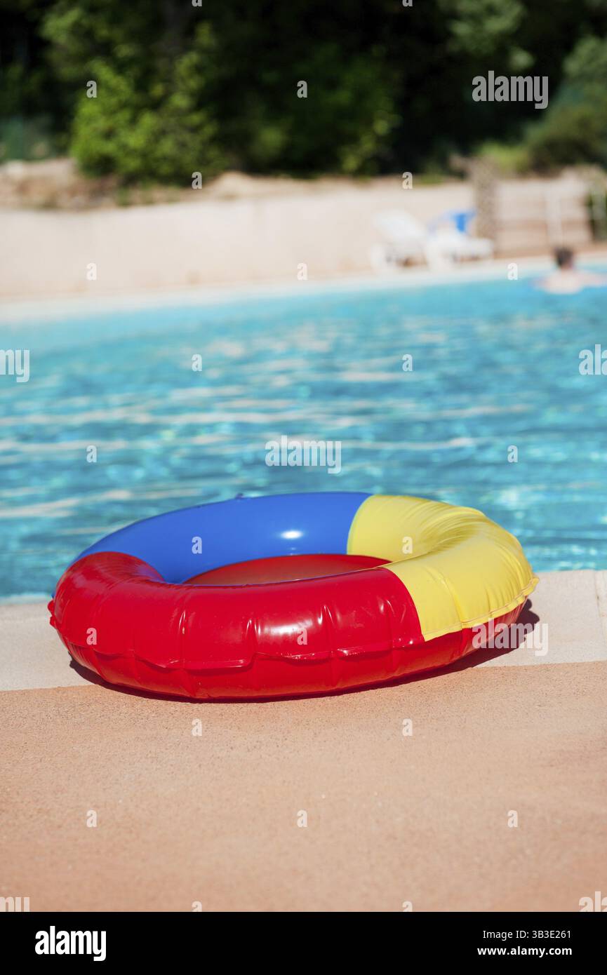 Colorful toy swimming tire at the pool Stock Photo - Alamy