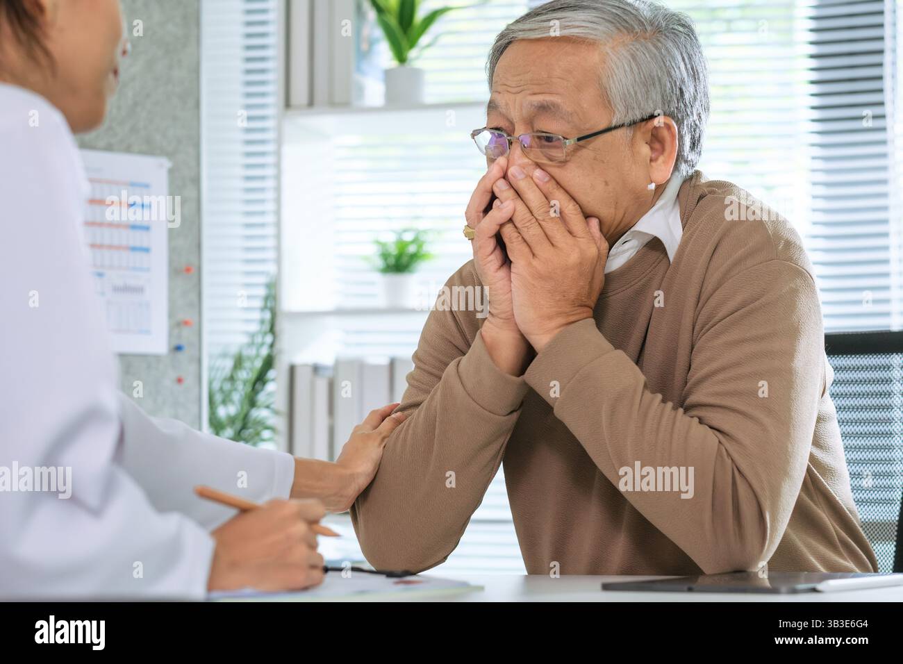 Doctor delivering bad news diagnosis with emotional support to senior ...