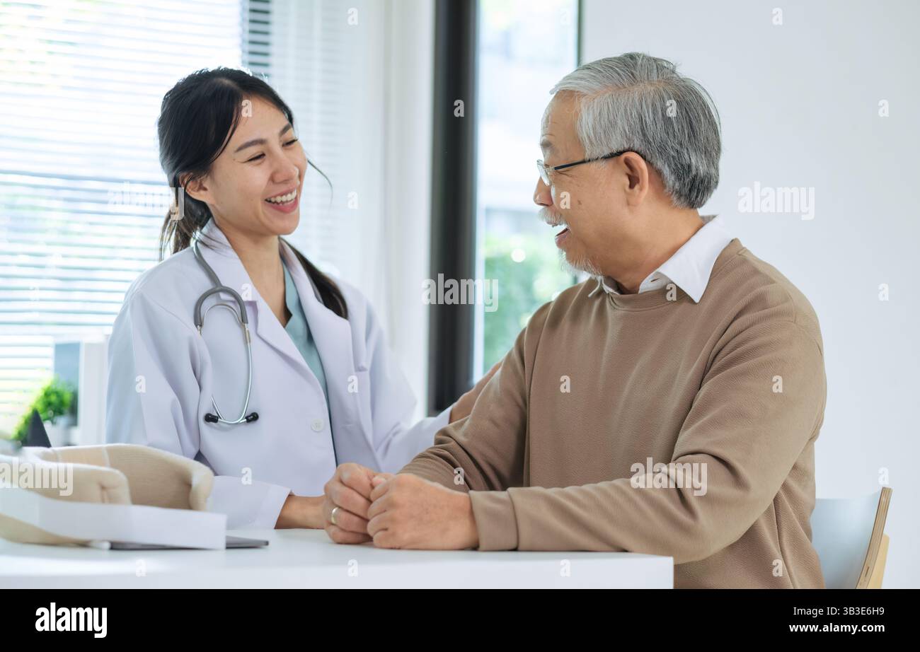 Doctor happily informs senior patient about full recovery during follow ...