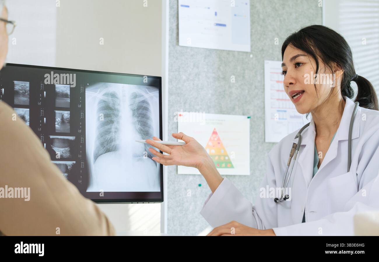 Doctor reviewing lung x-ray and diagnosing patient for respiratory disease at hospital ...