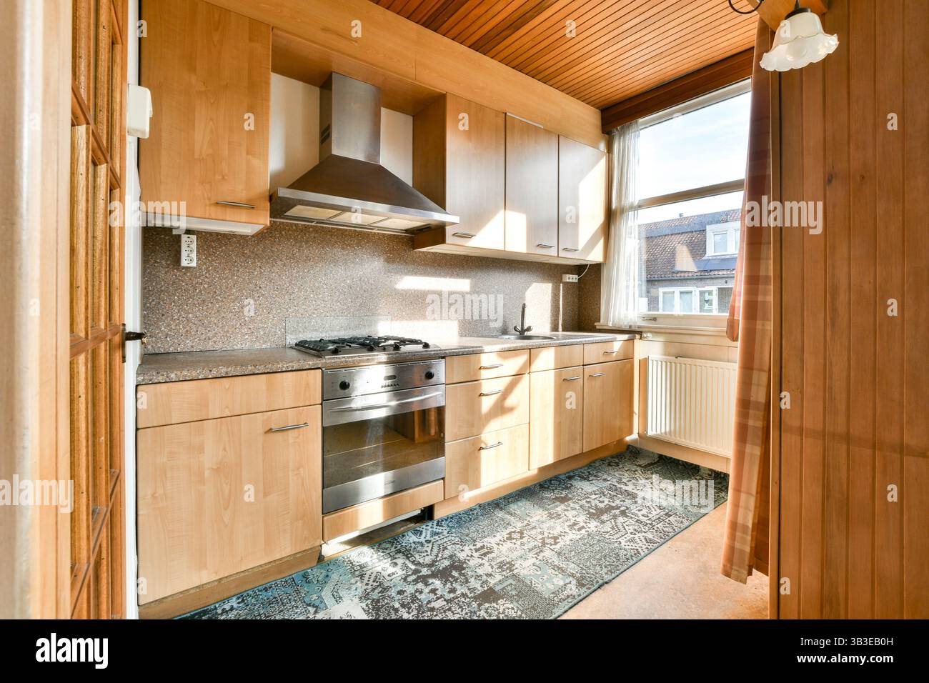 Bright and inviting kitchen featuring wooden cabinets, modern ...