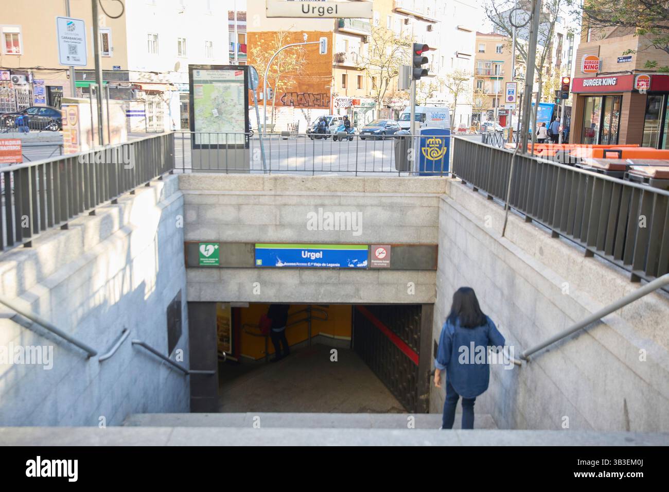 A woman enters the Urgel Metro station after service was restored due ...