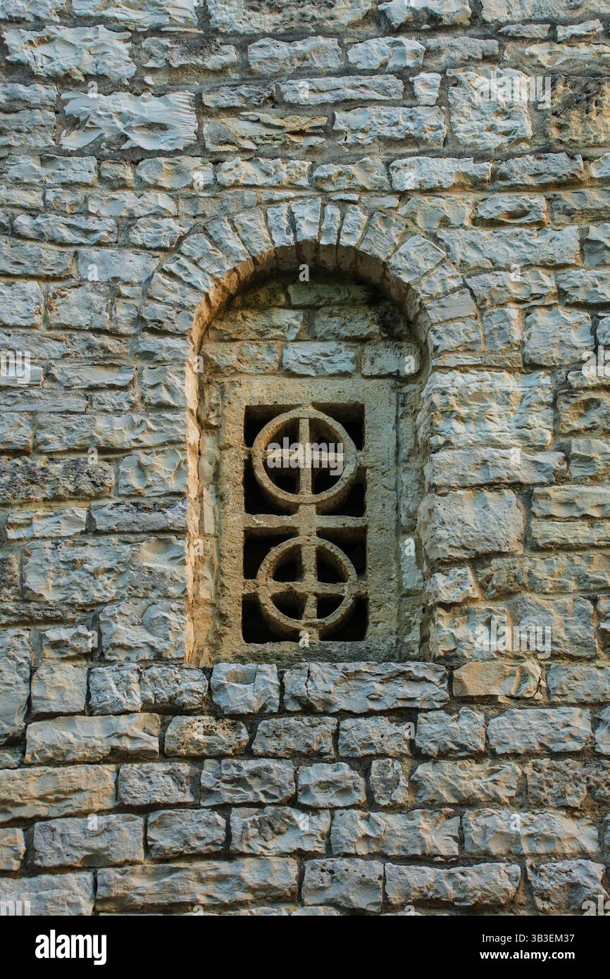 A deep-set blind window in the side of the Cathedral of the Assumption ...