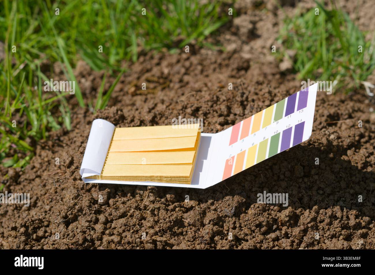 A litmus paper testing kit on damp earth. To determine the acidity or ...