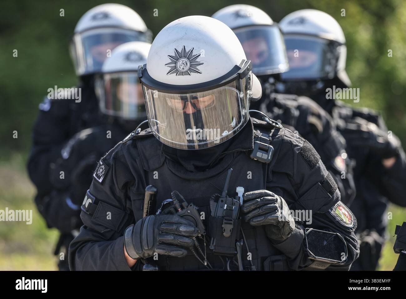 Cologne, Germany. 29th Apr, 2025. Riot police officers stand together ...