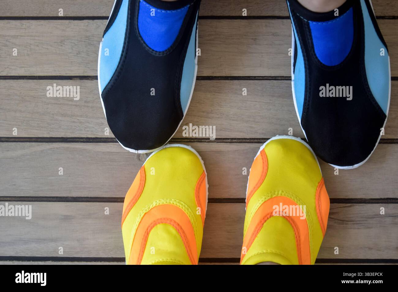 Mens and womens feet in protective slippers for swimming and walking on ...