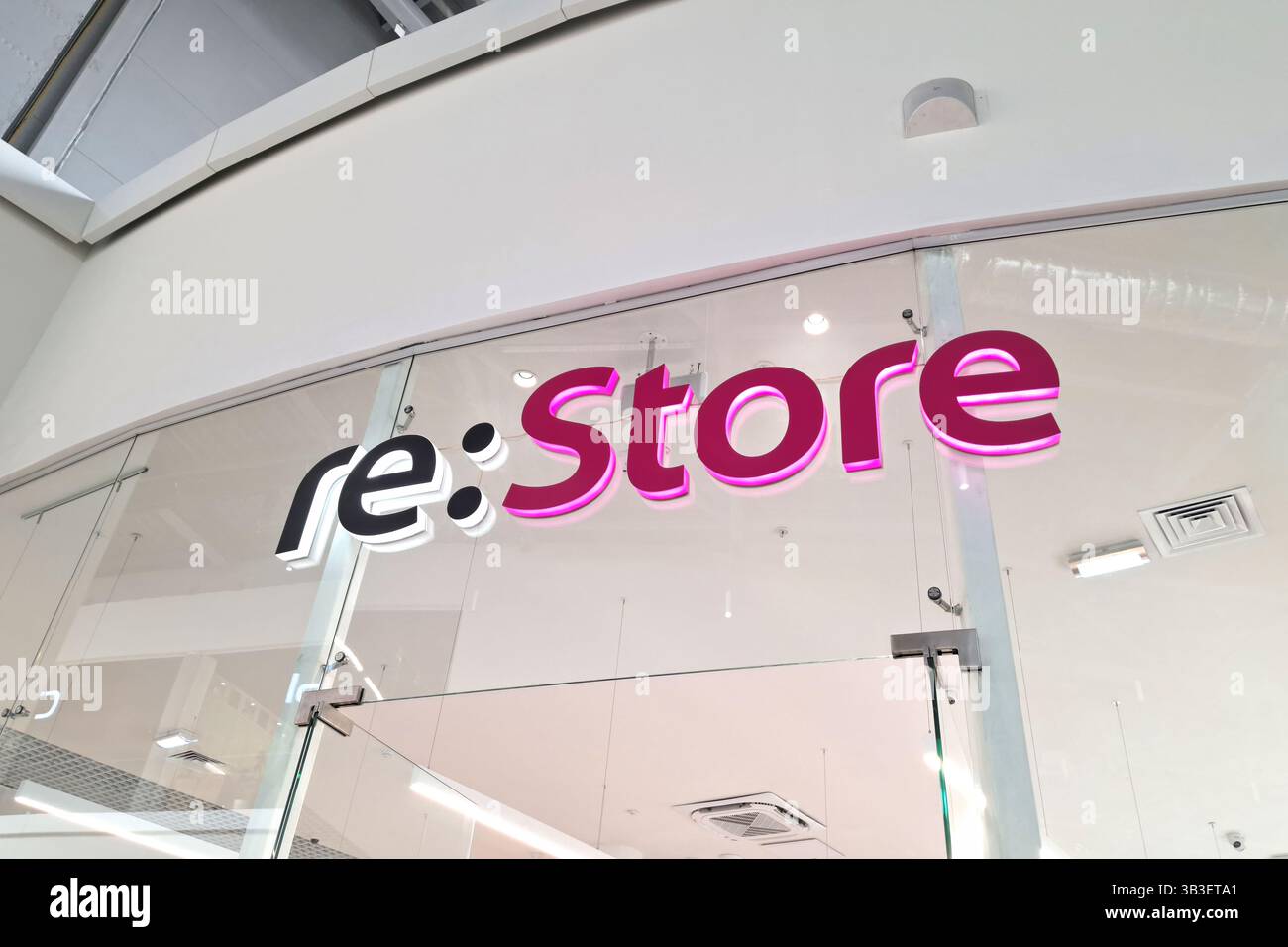 Moscow, Russia - April 26, 2025.Modern glass storefront with re Store ...