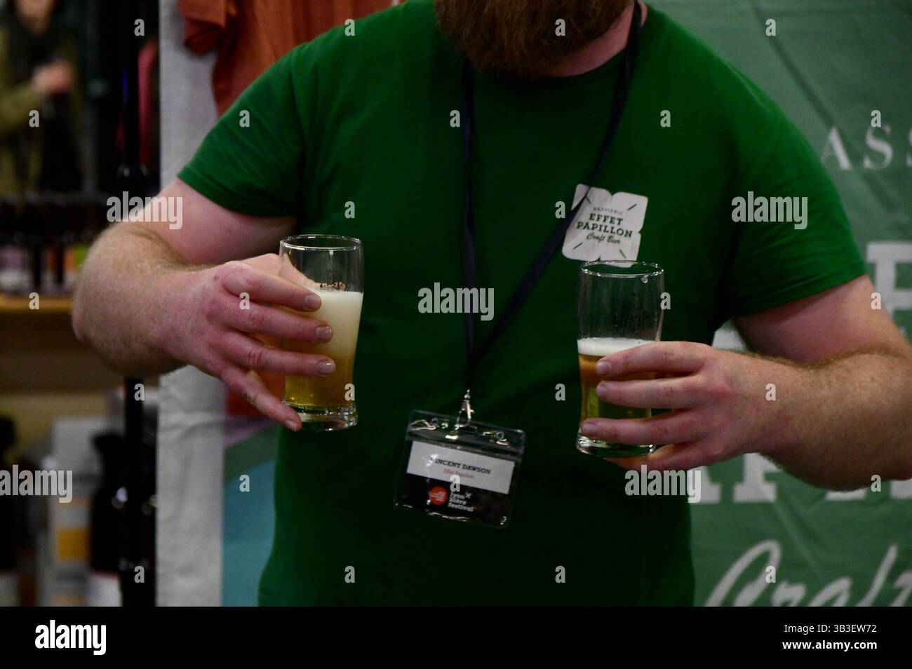 A man with two craft beers seen displayed at the 8th edition of the ...