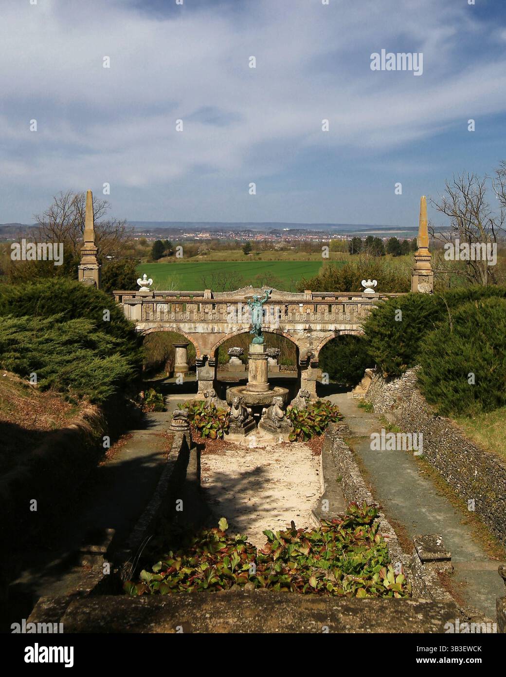Stone terrace fountain of Castle Roseburg overlooking green fields ...
