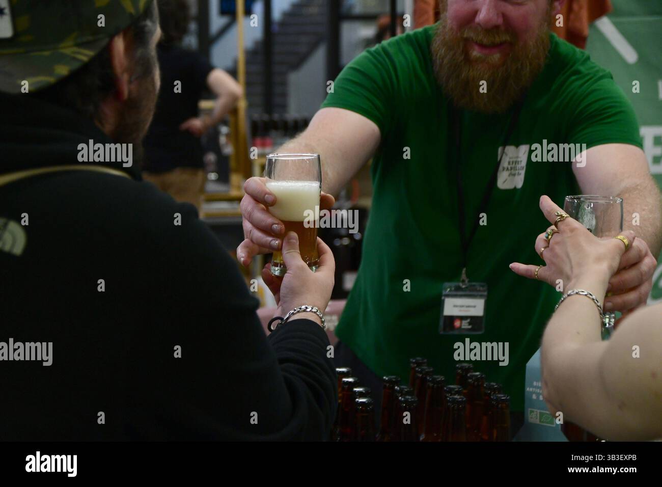 A man with two craft beers seen displayed at the 8th edition of the ...