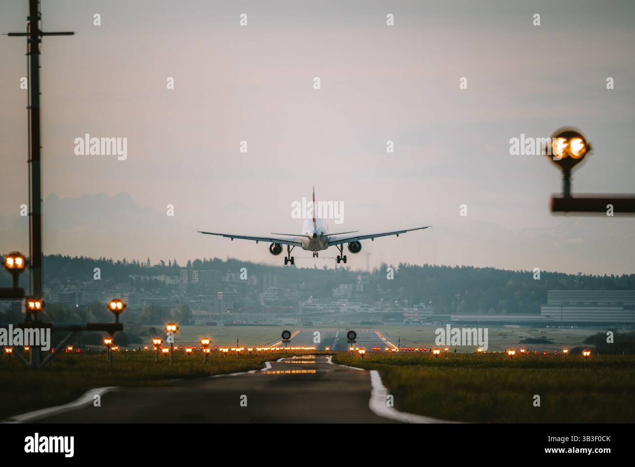 Commercial airplane seen from behind just before touching down and ...