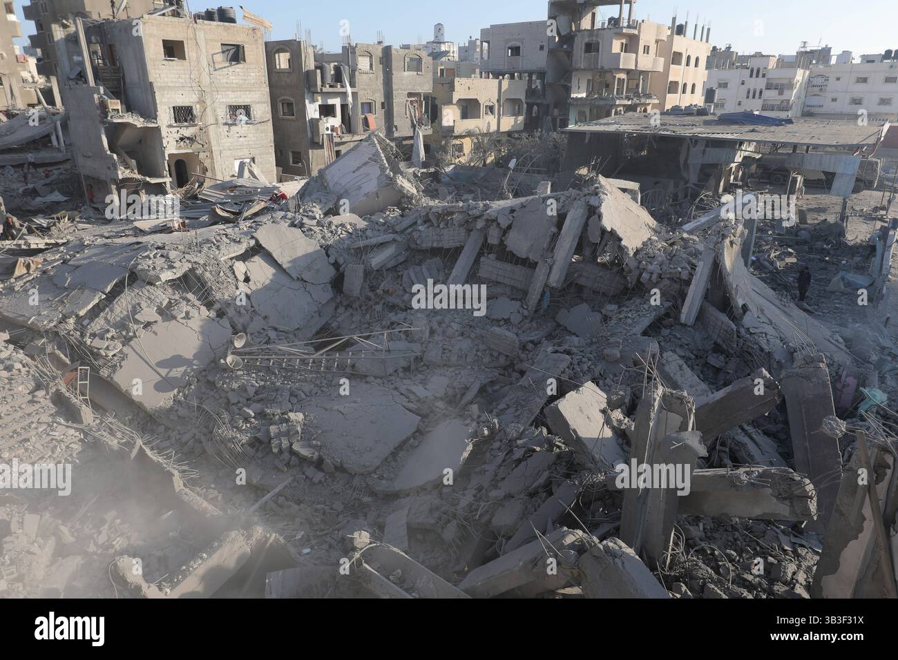 Palestinians inspect the damage, following overnight Israeli strikes ...