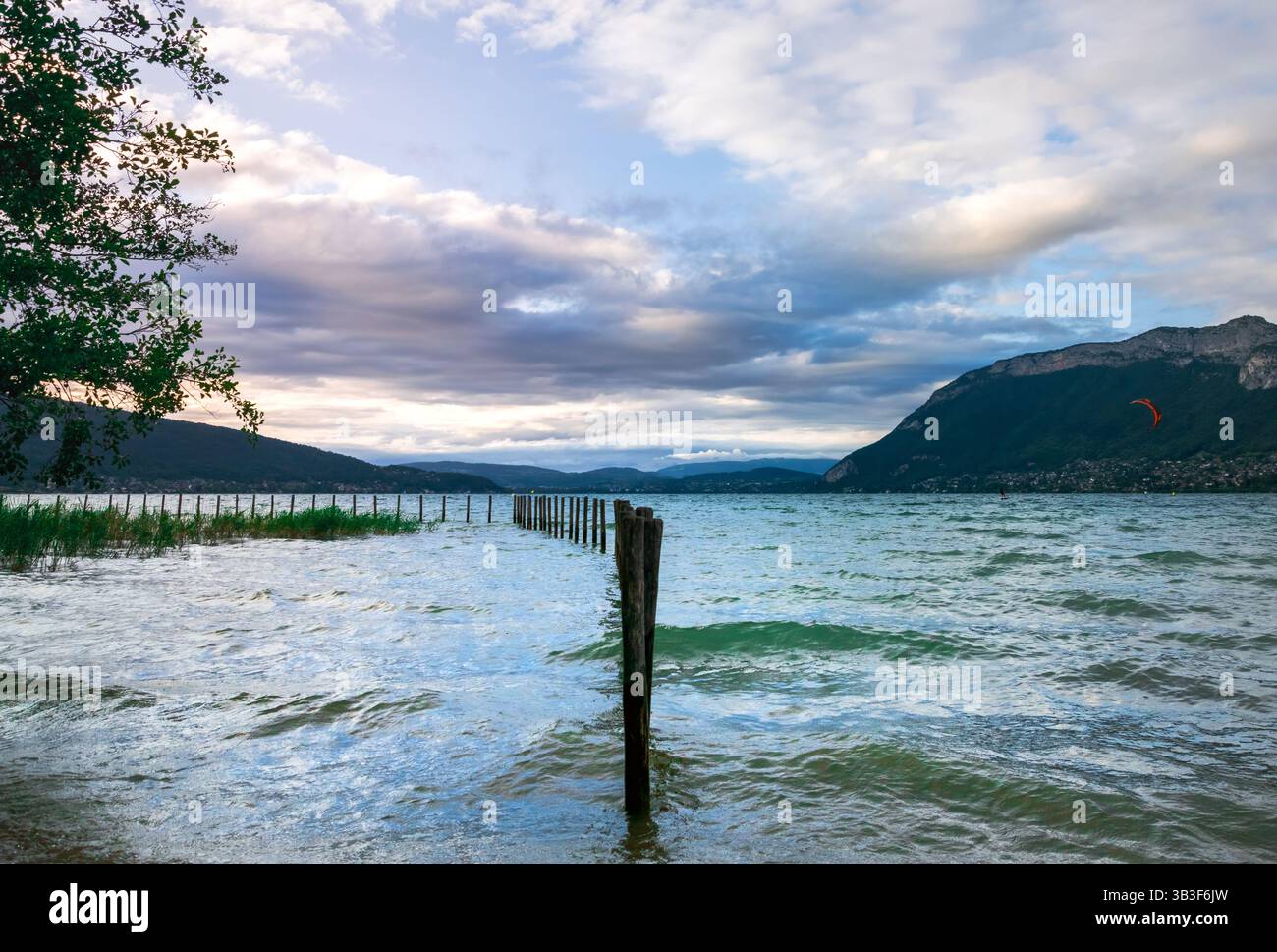 Lake Annecy under dramatic sky with the Alps at the background Stock ...