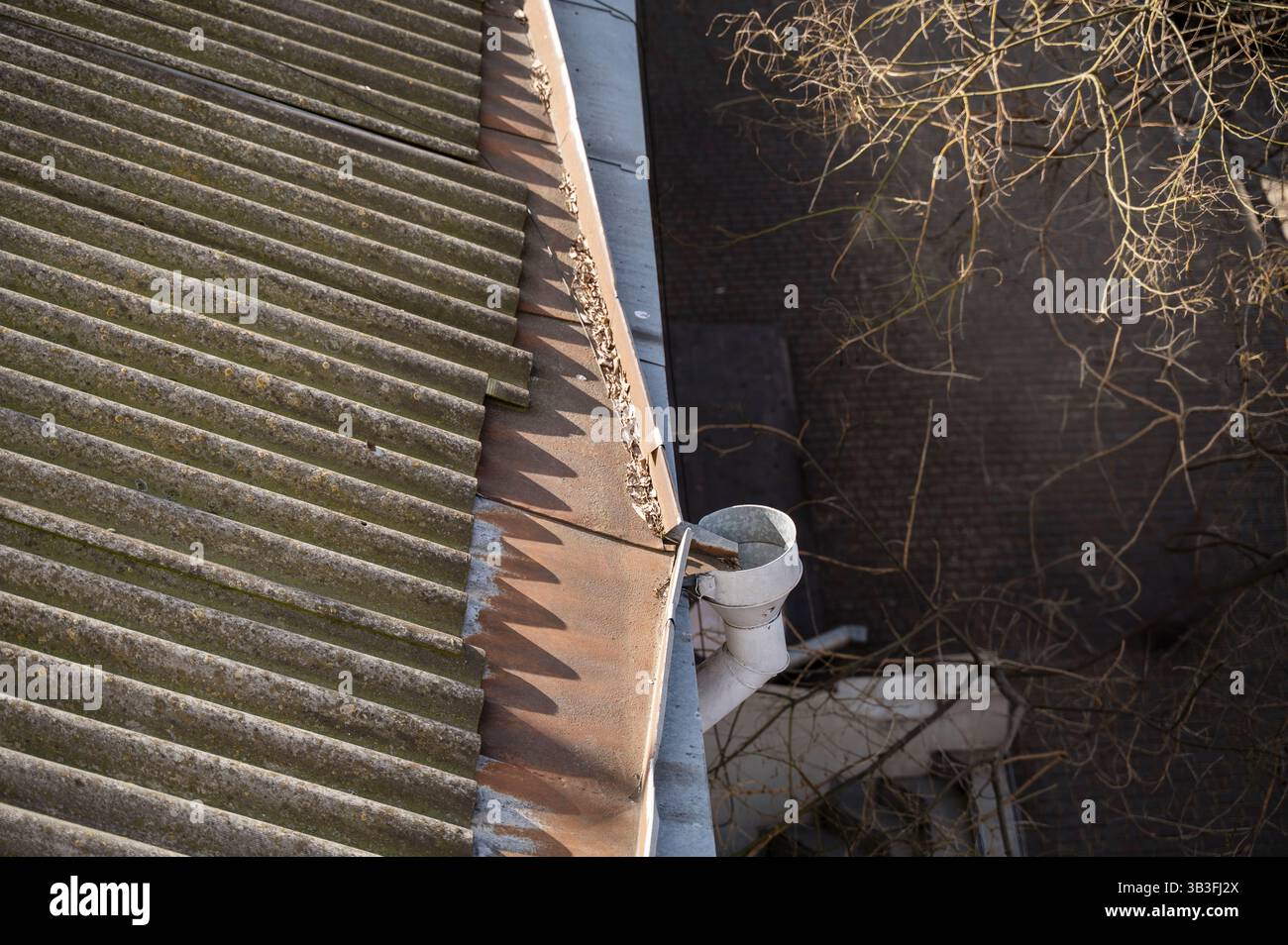 Roof gutter PVC pipes, old housing stock Stock Photo - Alamy