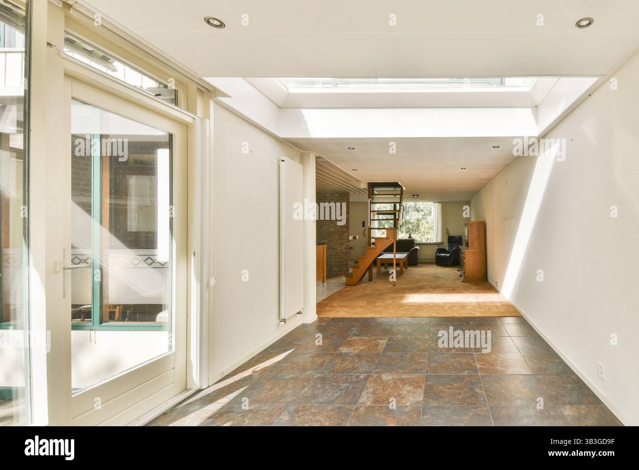 A bright and airy modern interior featuring large windows that invite ...